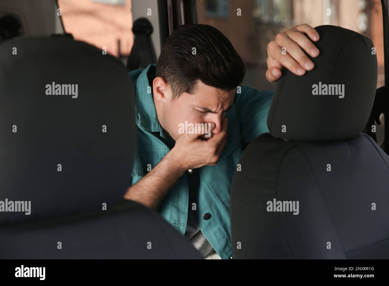 Man vomiting in bag hi-res stock photography and images - Alamy