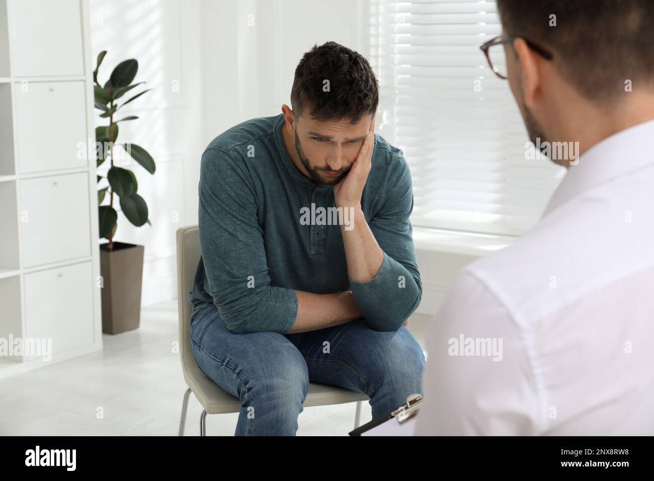 Psychotherapist working with drug addicted man indoors Stock Photo - Alamy