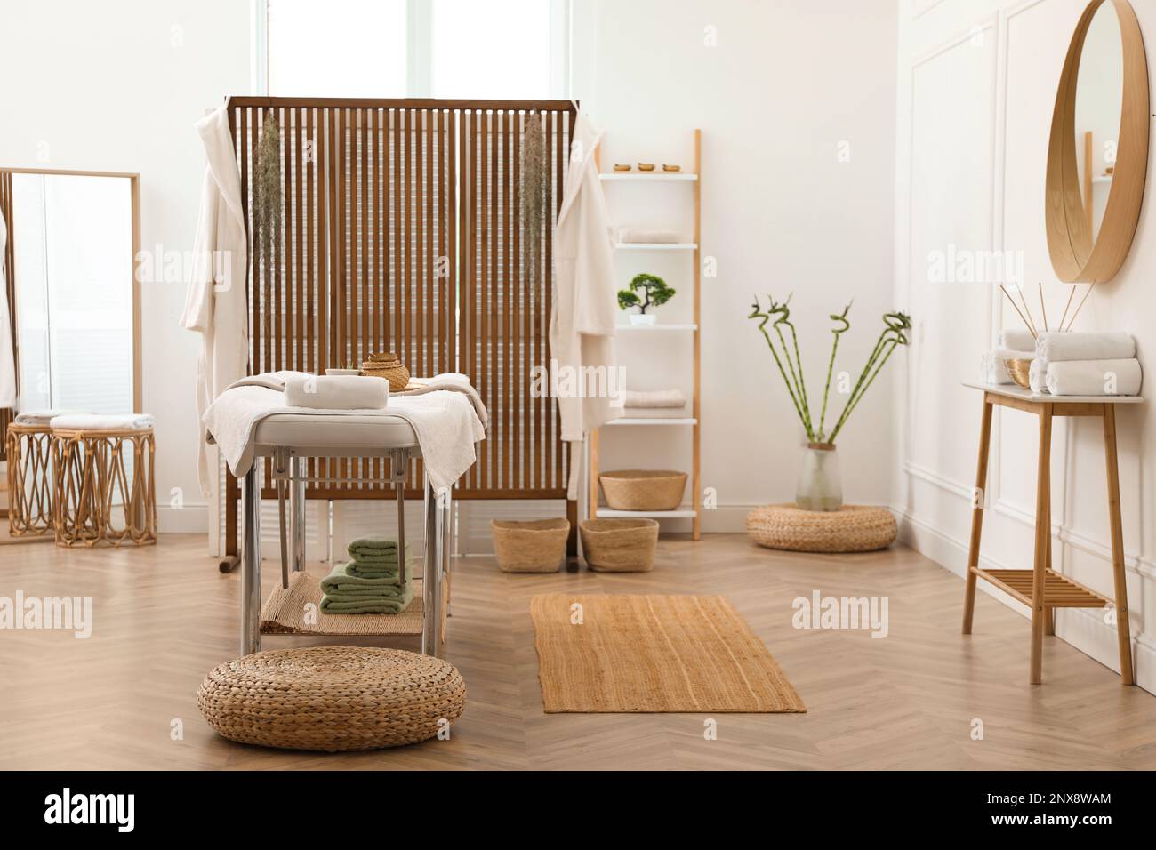 Stylish room interior with massage table in spa salon Stock Photo - Alamy