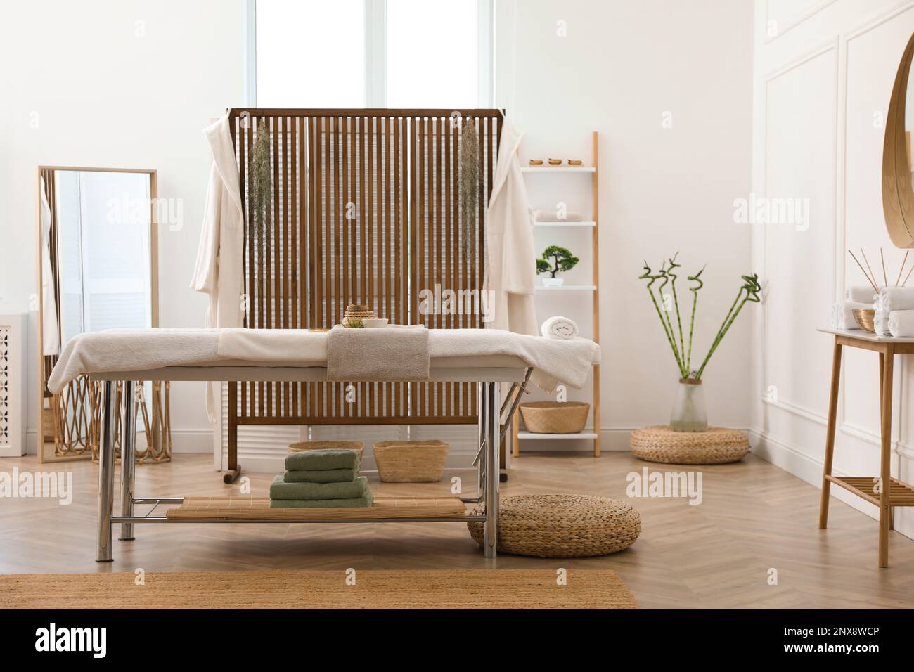 Stylish room interior with massage table in spa salon Stock Photo - Alamy