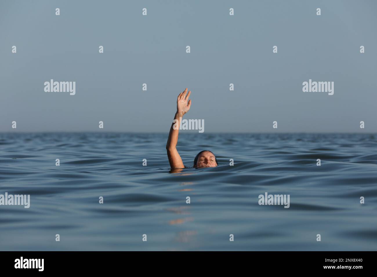 Drowning woman reaching for help in sea Stock Photo - Alamy