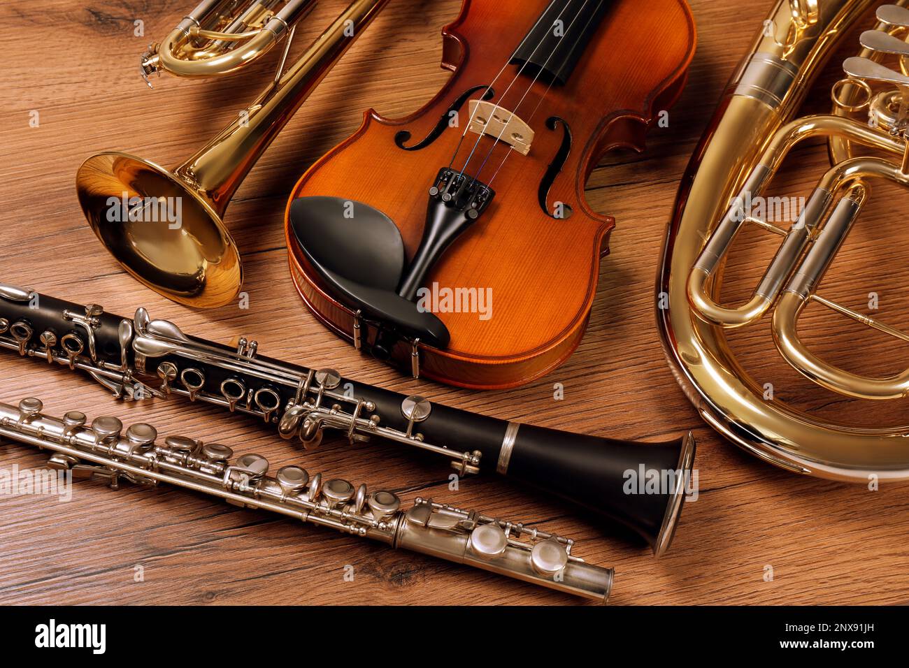 Set of different musical instruments on wooden background, closeup ...