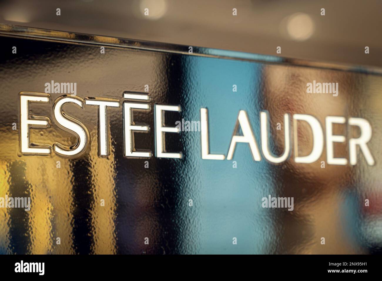 The logo of the world cosmetics manufacturer Estee Lauder on a golden ...