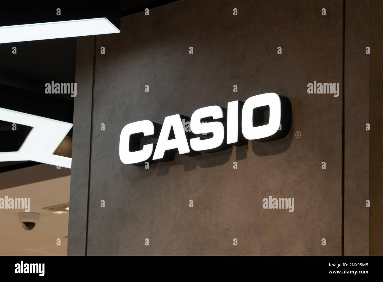 The logo of Casio, a Japanese electronics manufacturer on a brown ...