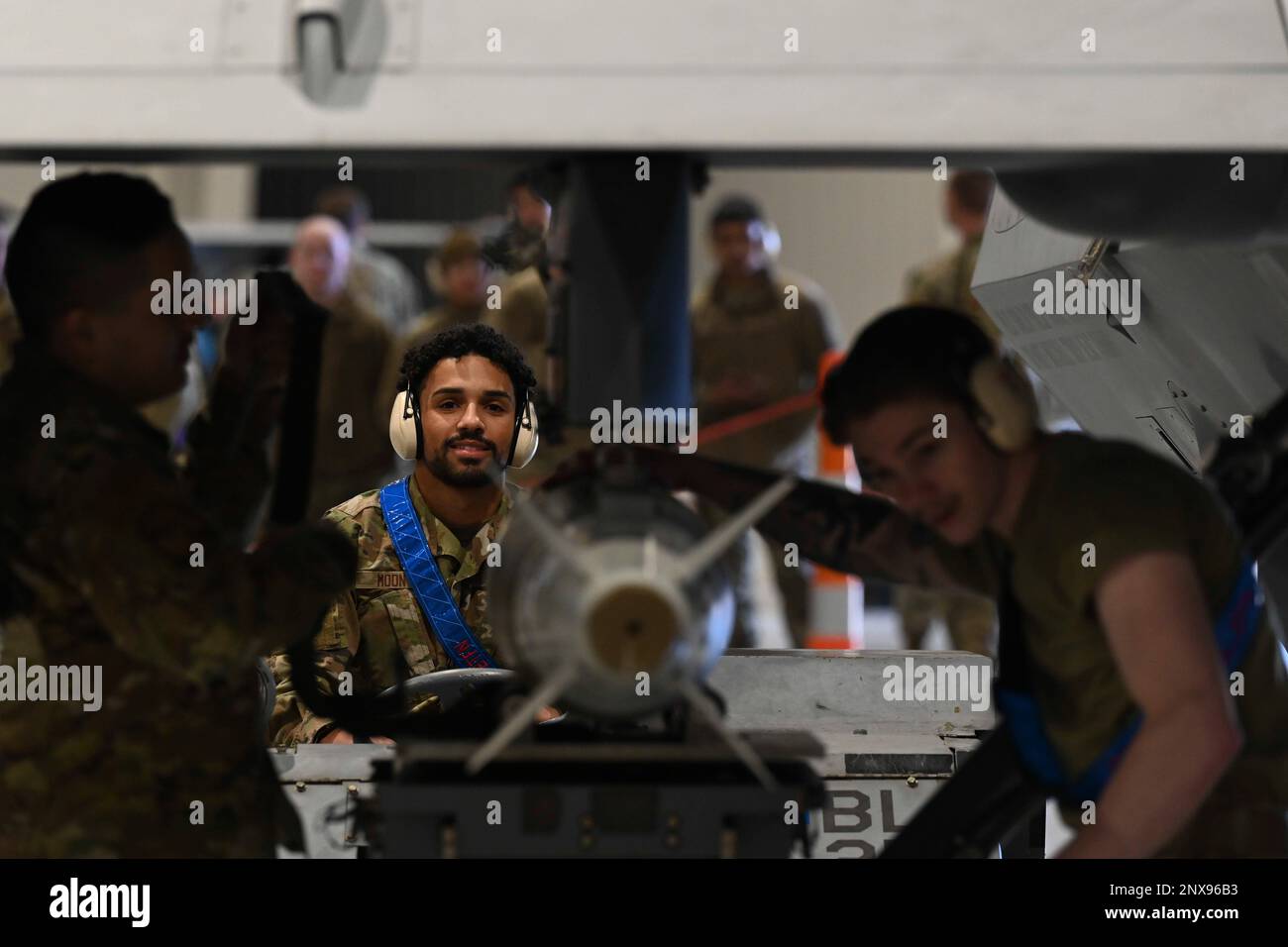 U.S. Air Force Airman 1st Class Roemello Moon, center, 49th Aircraft ...