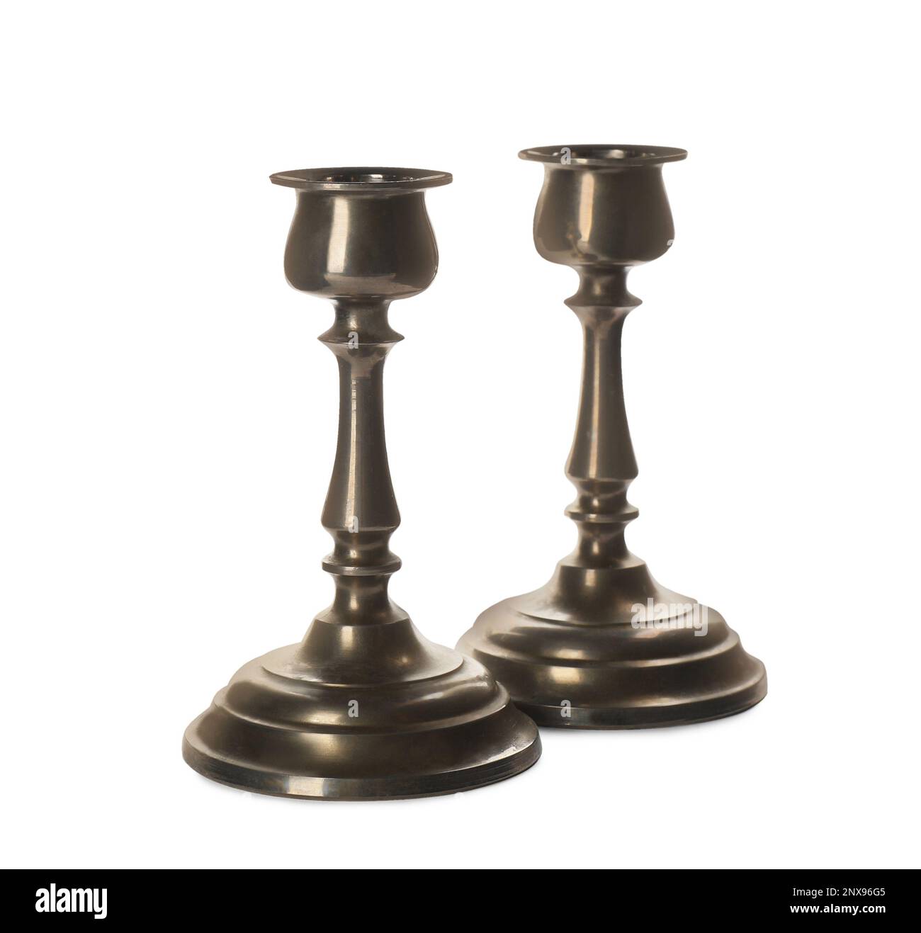 Two vintage metal candlesticks on white background Stock Photo - Alamy