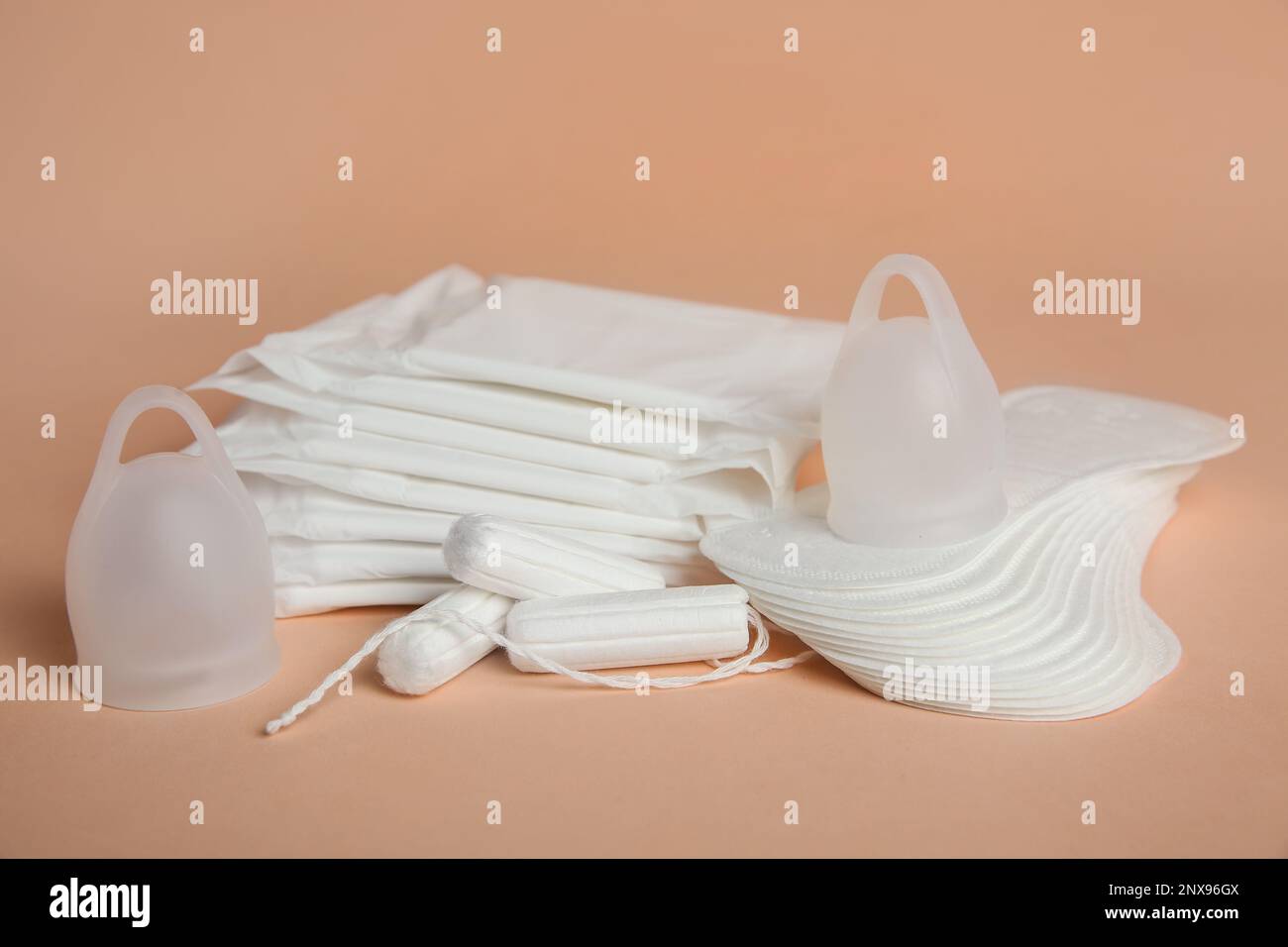 Menstrual pads and other period products on pale orange background ...