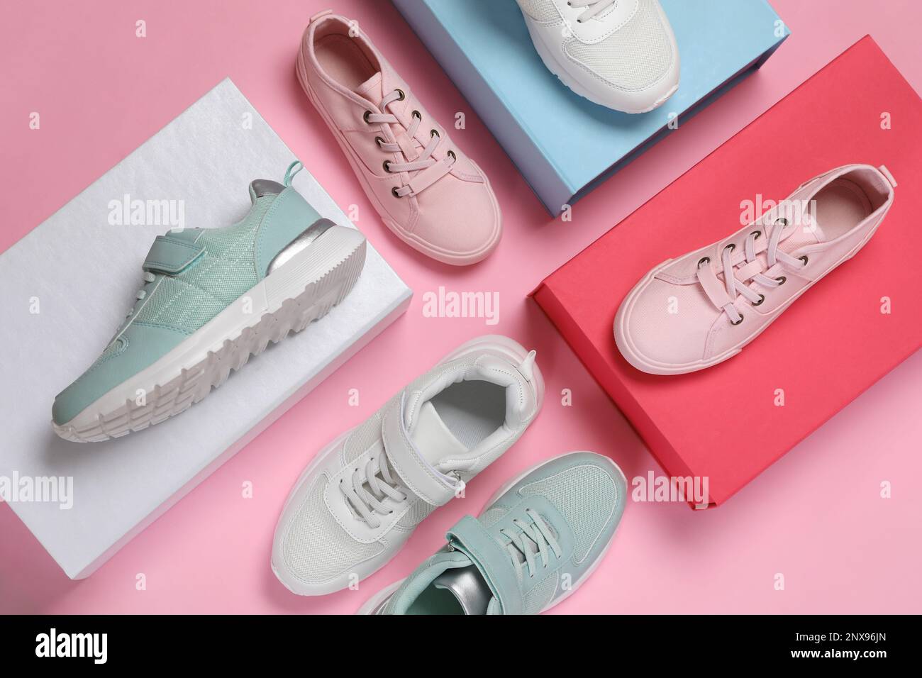 Flat lay composition with different stylish sports shoes on pink ...