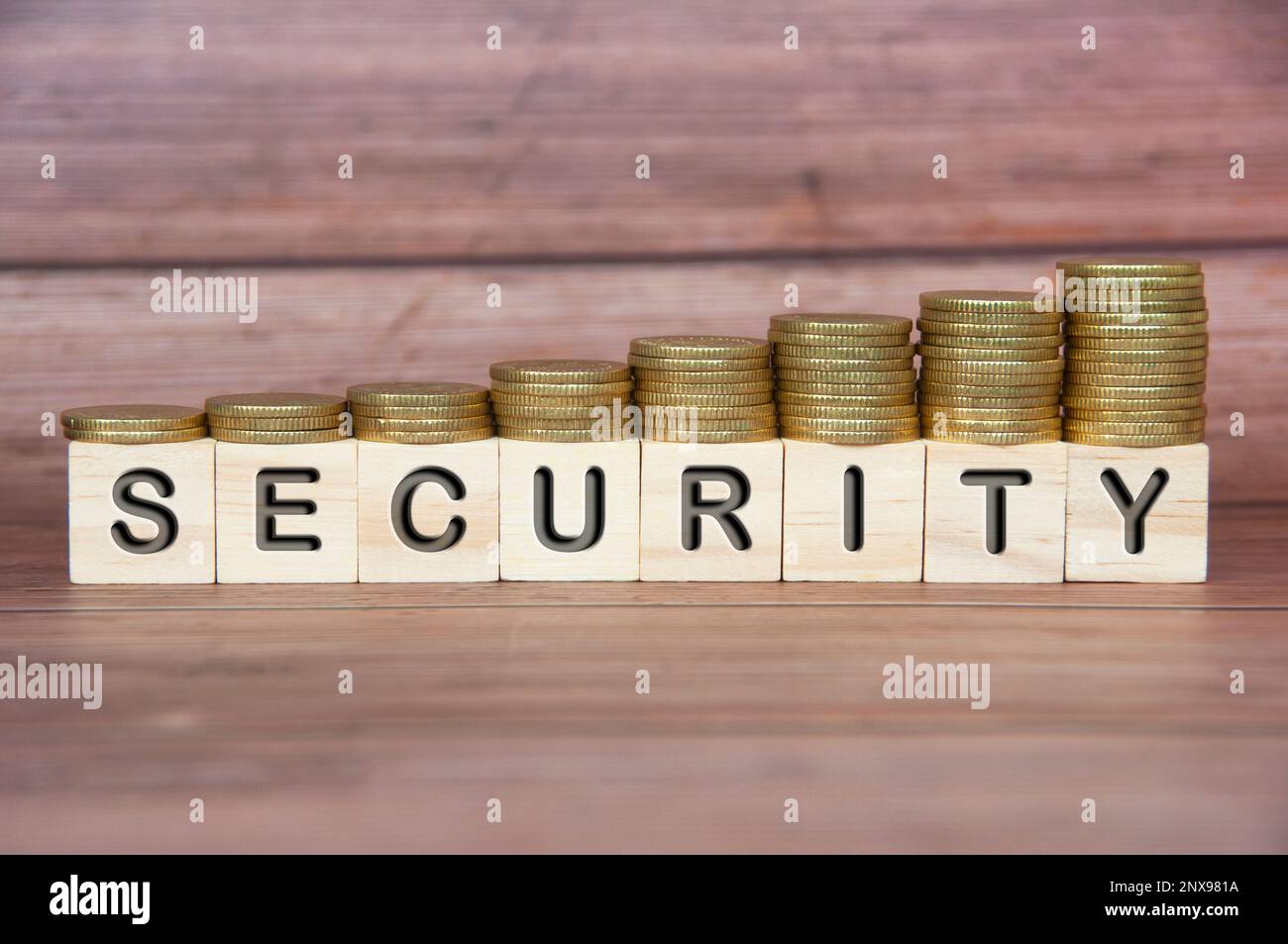 SECURITY text engraved on wooden blocks with gold coins on wooden ...