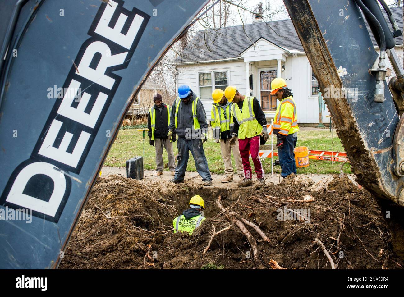 Saginaw resident Ron Baston works as part of a crew digging out and ...