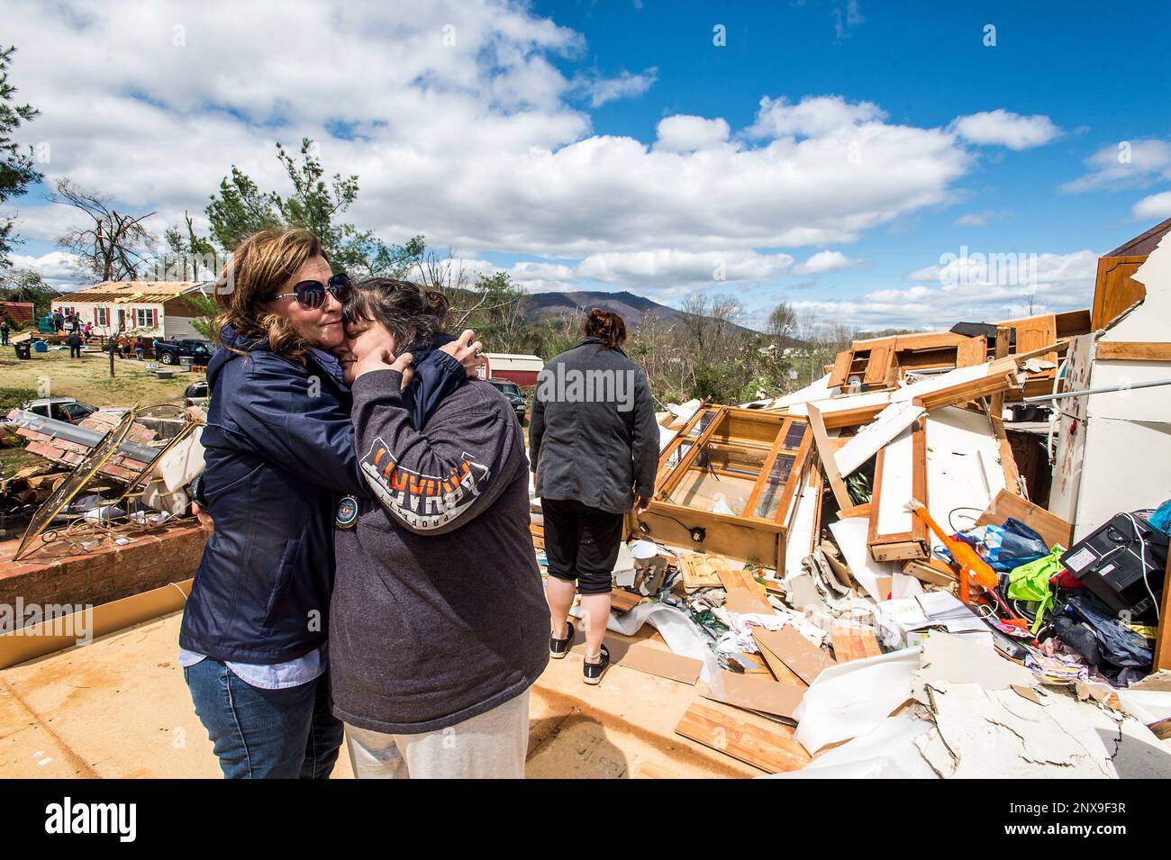 Rebecca Farley, left, hugs her sister Rene Sellick, as Rene's daughter ...