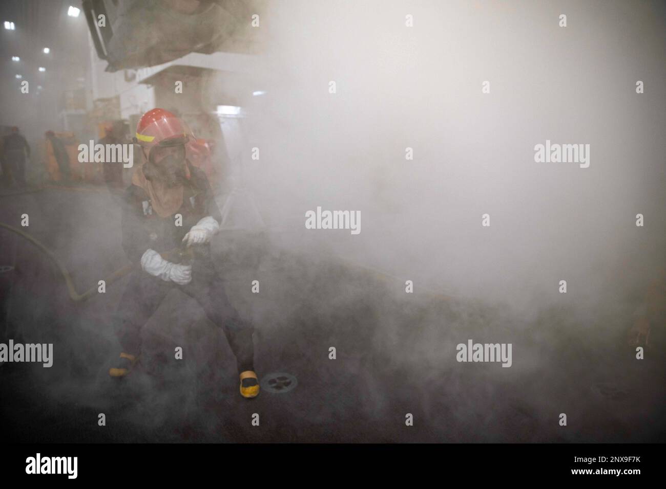 230106-N-IV962-1159 Fireman Logan Conrad combats a simulated fire ...