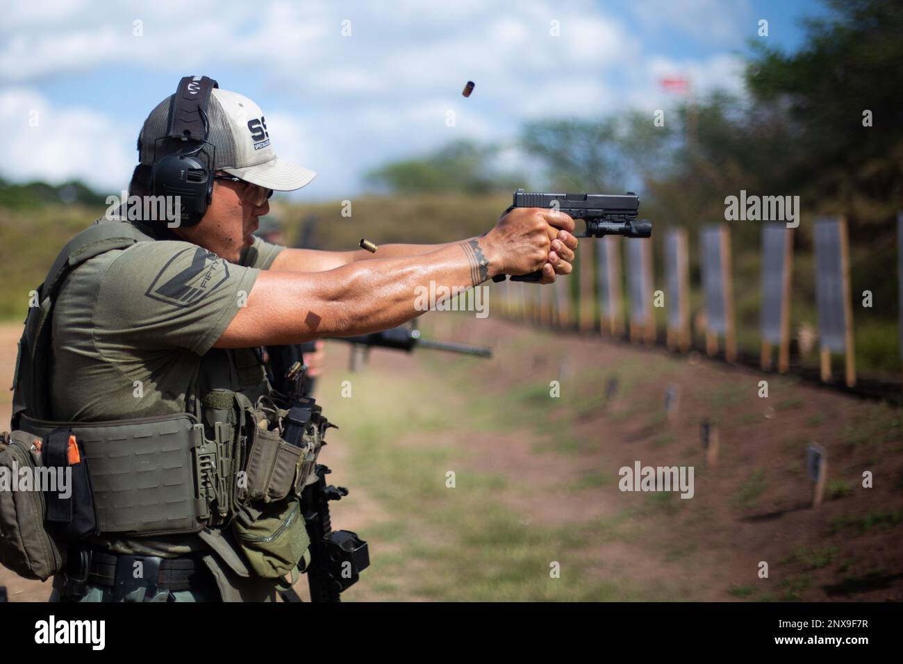 An officer with the Honolulu Police Department fires an M9 service ...
