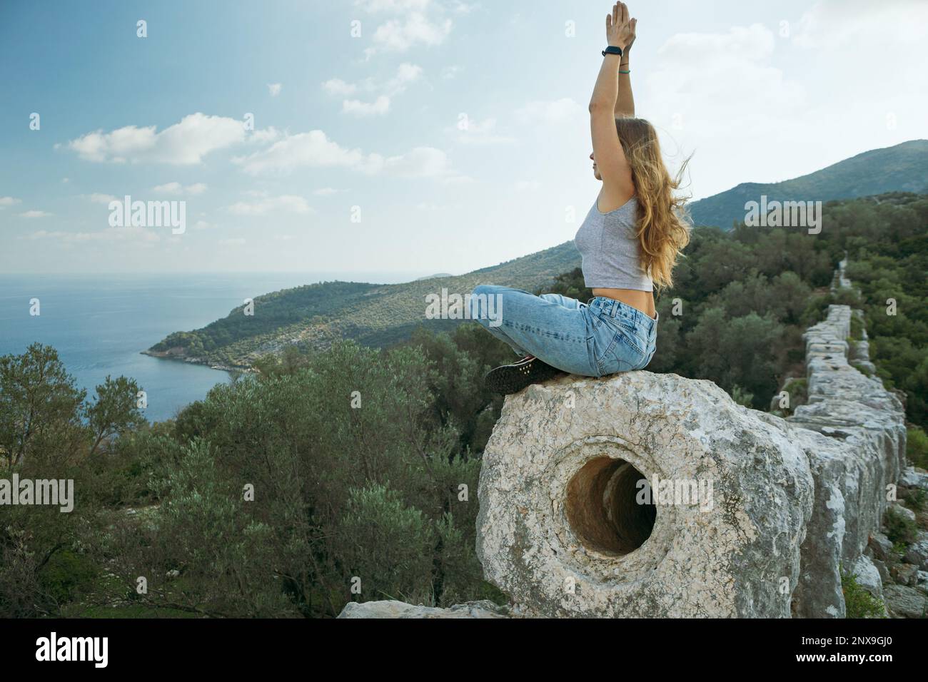 Young woman relax in yoga pose at ruins of old Roman Delikkemer ...