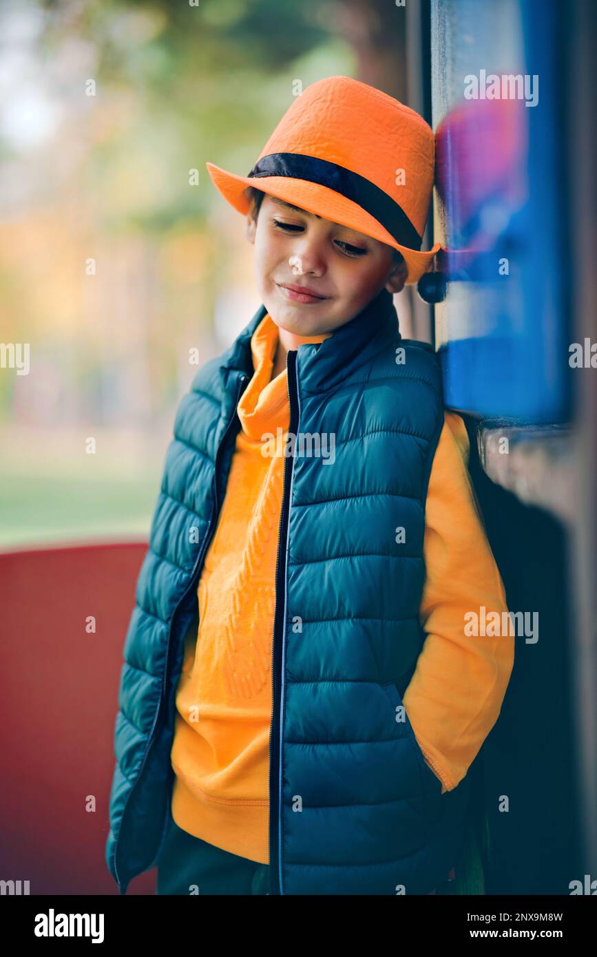 Portrait of a cute boy with an orange hat on the playground Stock Photo ...