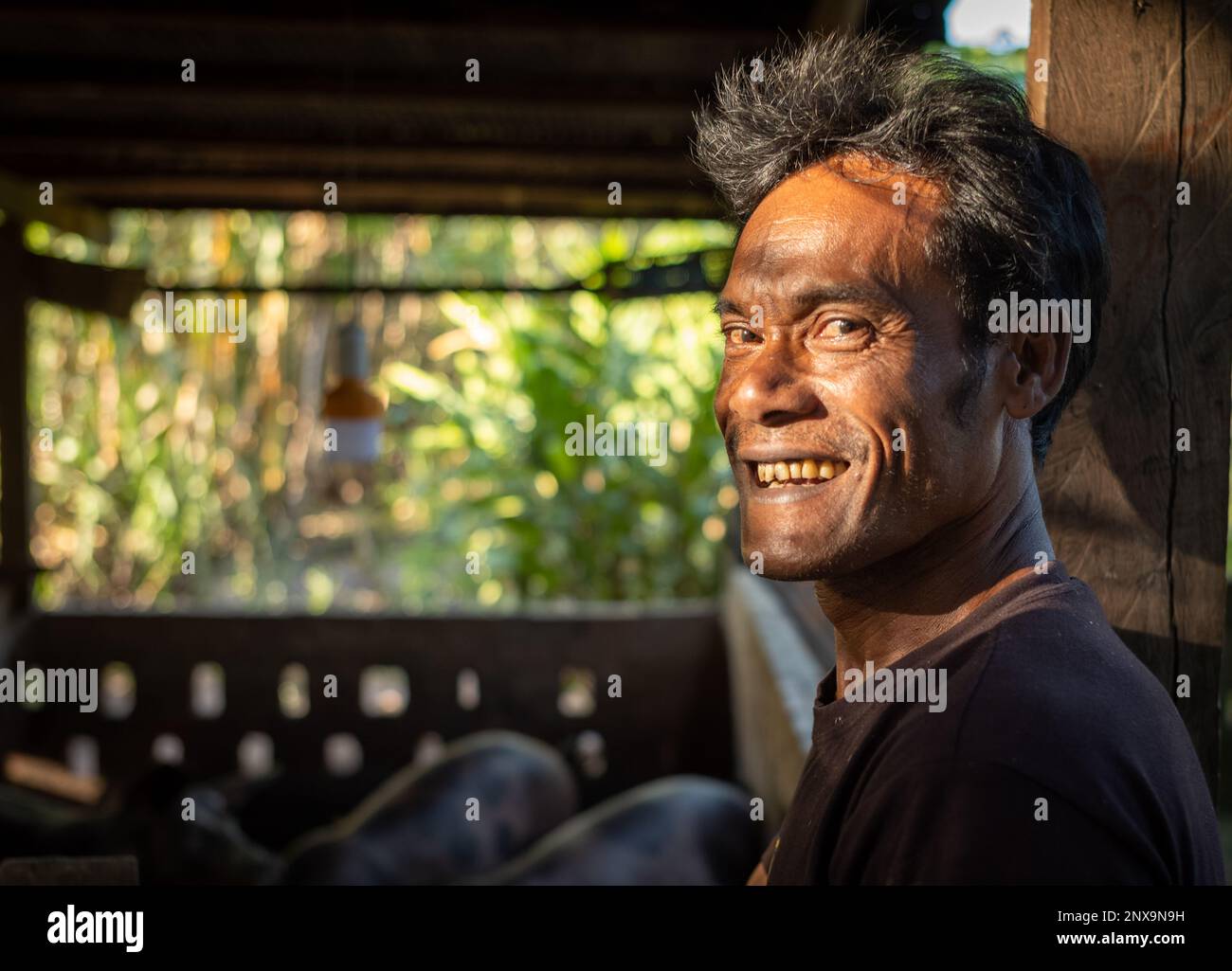 A man in a rural village in Siem Reap province, Cambodia, stands next ...