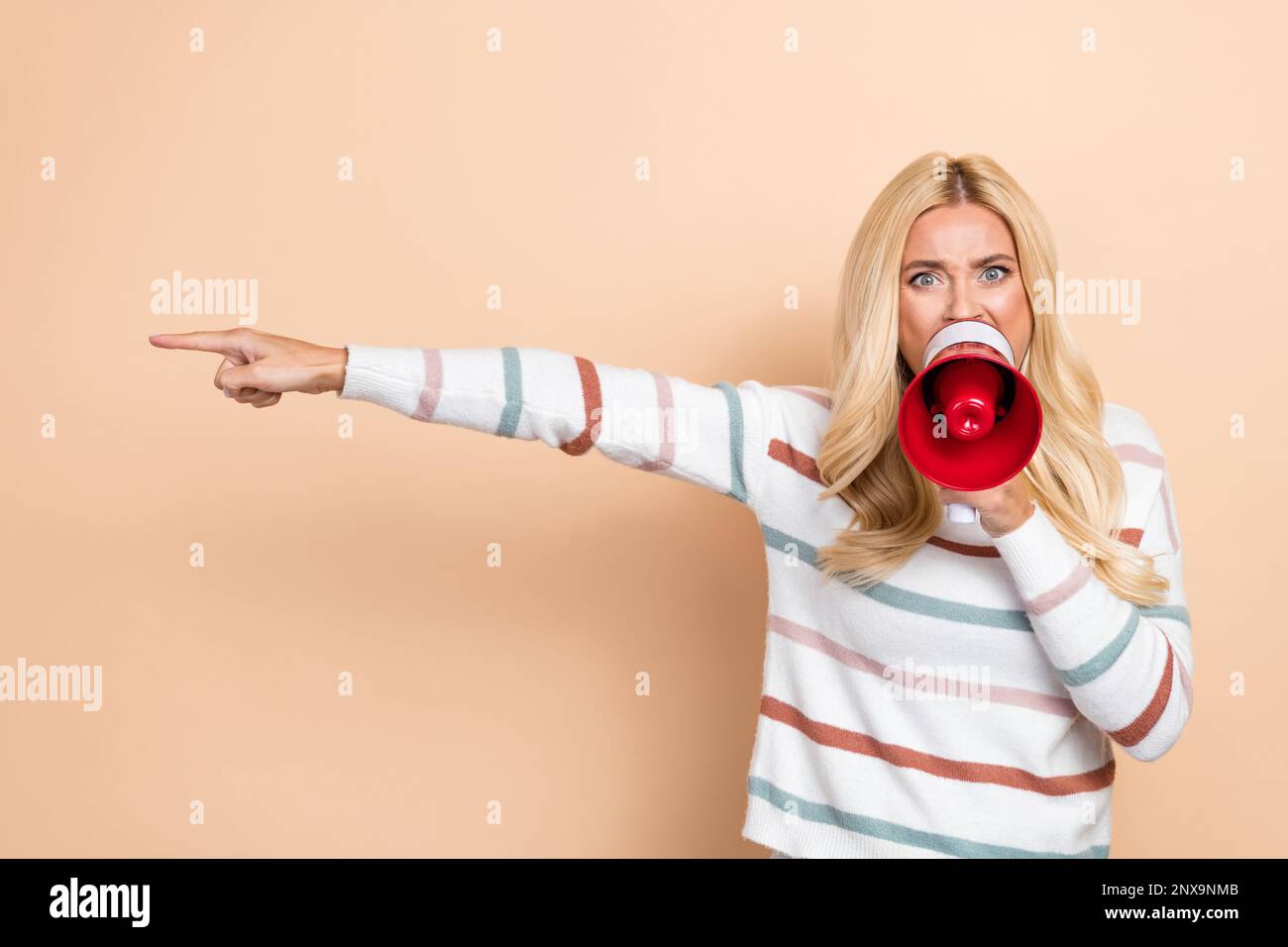 Photo of mature age woman striped jumper angry furious point finger ...