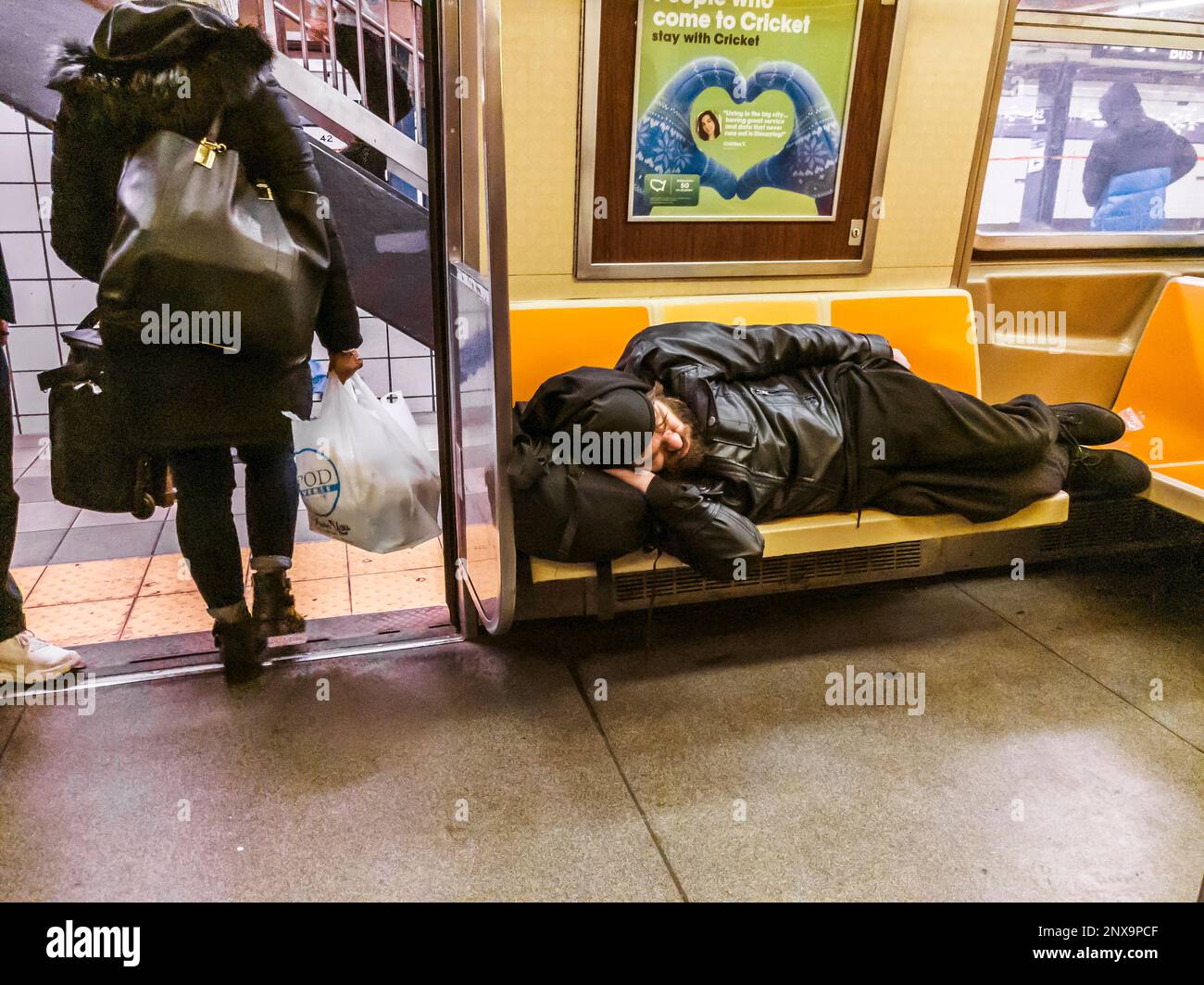 Homeless man sleeping on an A line subway train in New York takes up ...