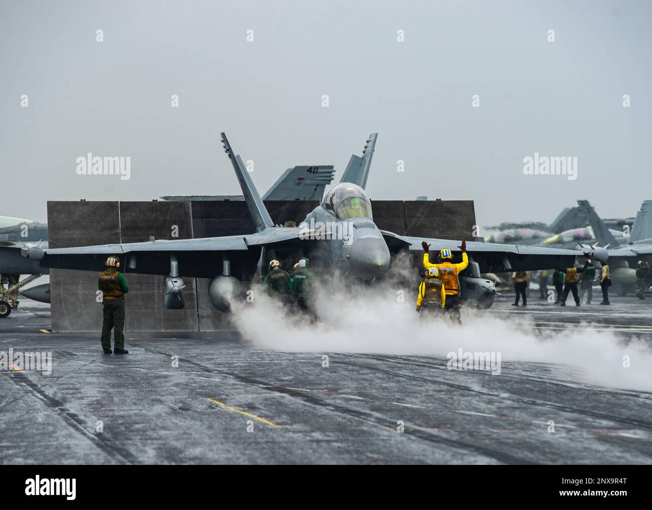 230119-N-MH015-1083 SOUTH CHINA SEA (Jan. 19, 2023) A U.S. Navy Sailor directs an E/A-18G ...