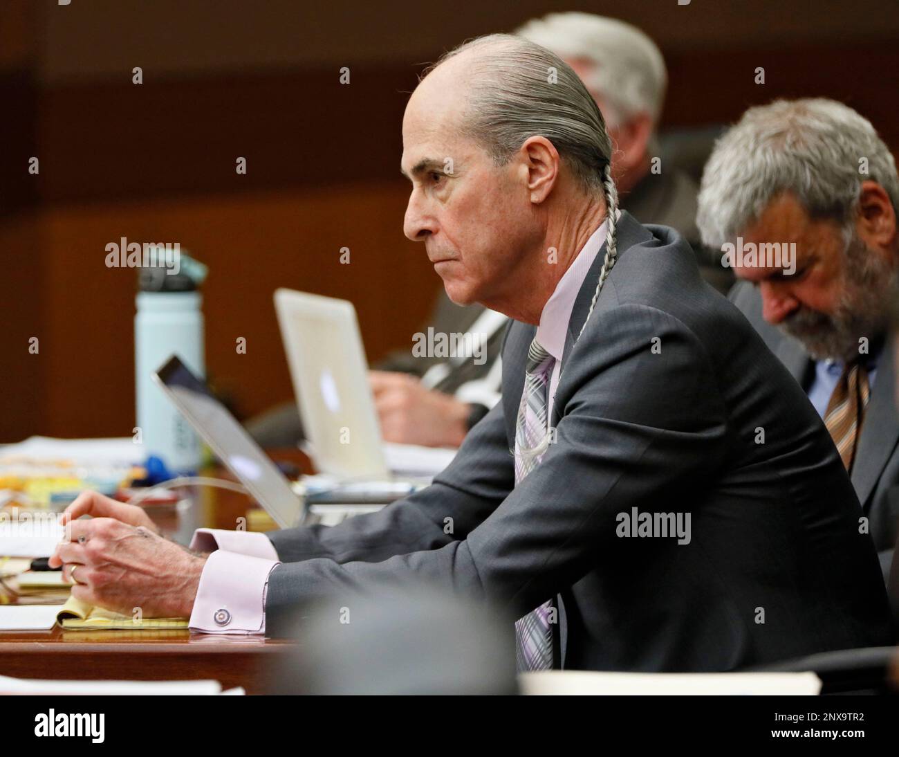 Bruce Harvey, one of Tex McIver's attorneys, watches cross examination ...