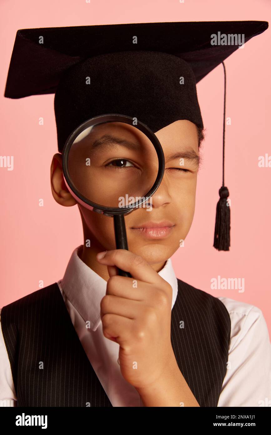 Look at world through magnifying glass. Curious school age american ...