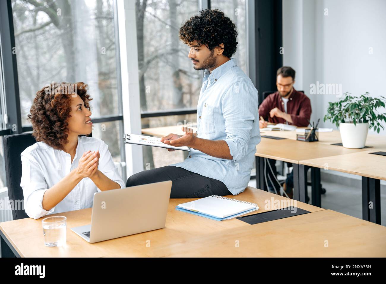 Teamwork concept. Two successful employees of the company of different ...