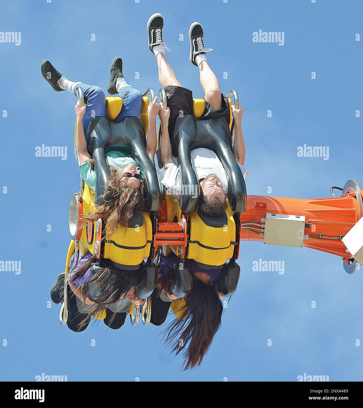 And away we go! -- Fairgoers get their thrills flying upside down on ...
