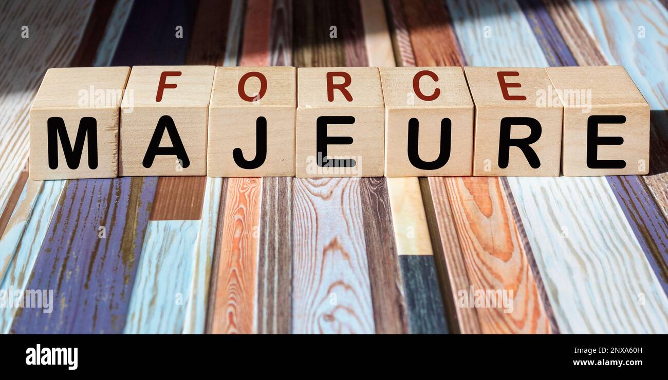 Force majeure text on wooden blocks lying on vintage background. Can be ...