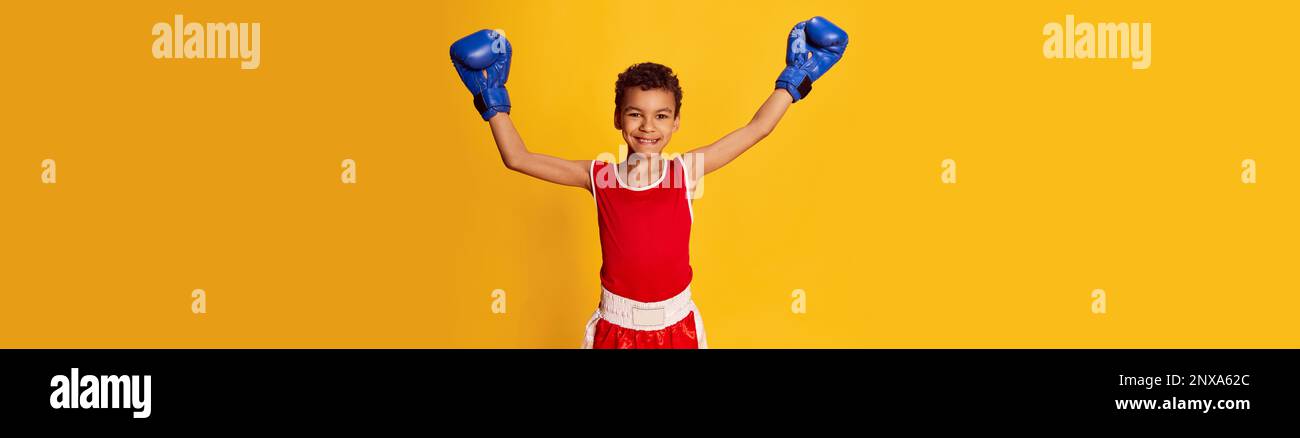 Horizontal banner with sportive little boy, beginner boxer in sports ...