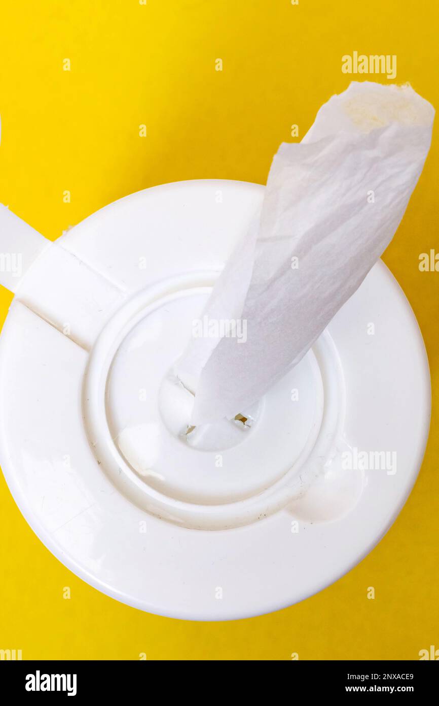 Disinfectant wipes in packaging on a yellow background close up, top ...