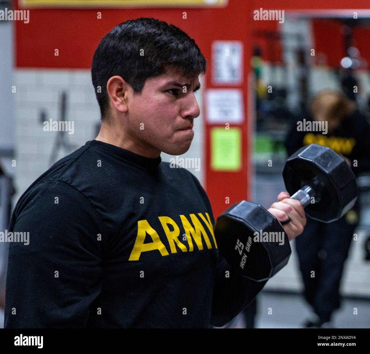 A Soldier assigned to the 1st Infantry Division performs 25-pound bicep ...