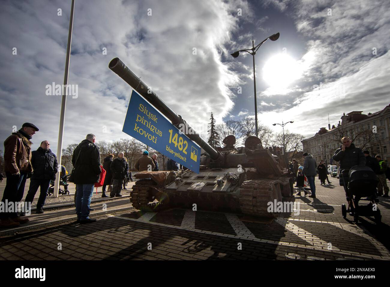 People stand by a destroyed Russian tank T-72B, installed as a symbol ...