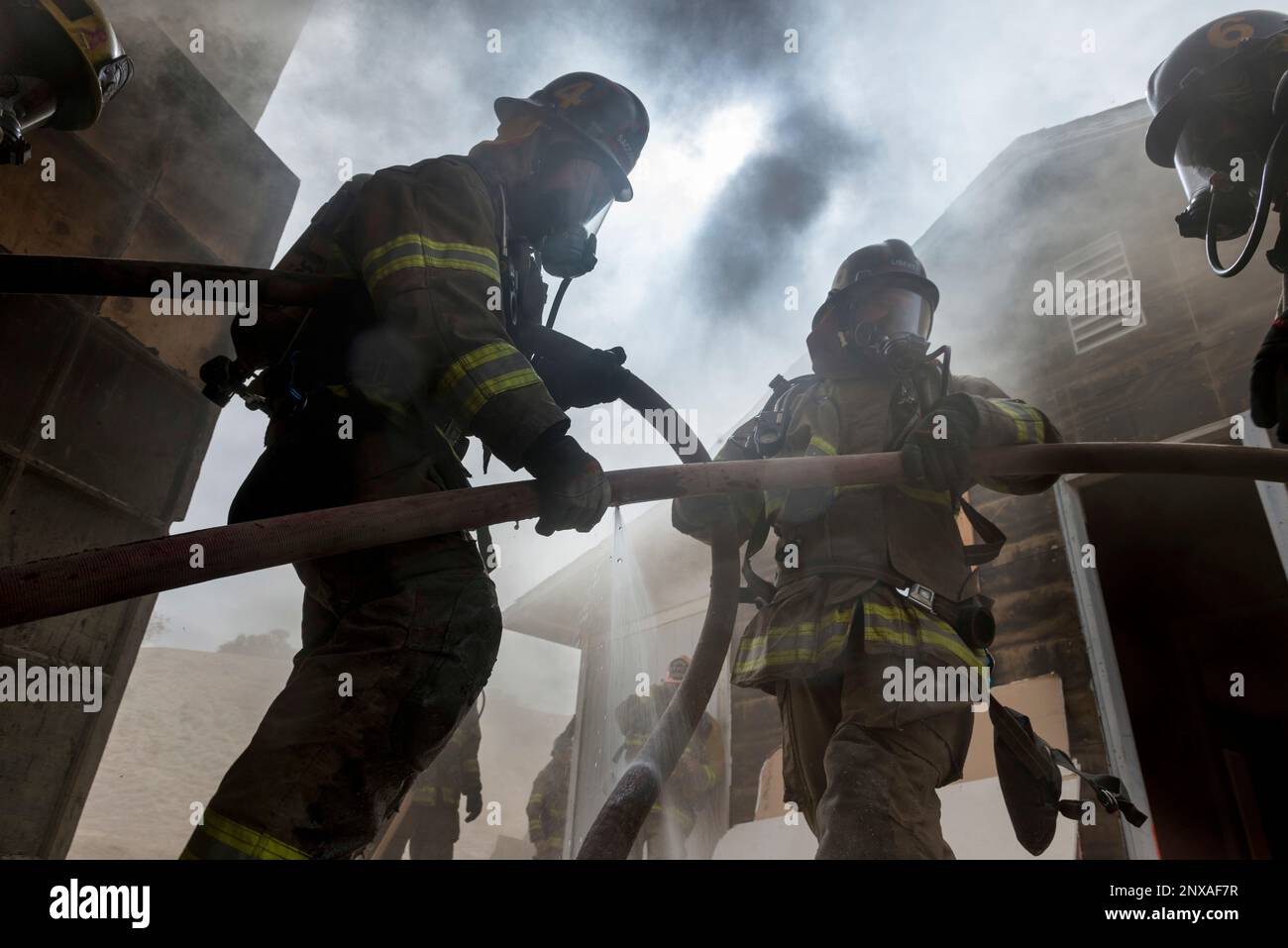 Victor Valley College Fire Academy cadets carry out a broken hose while ...