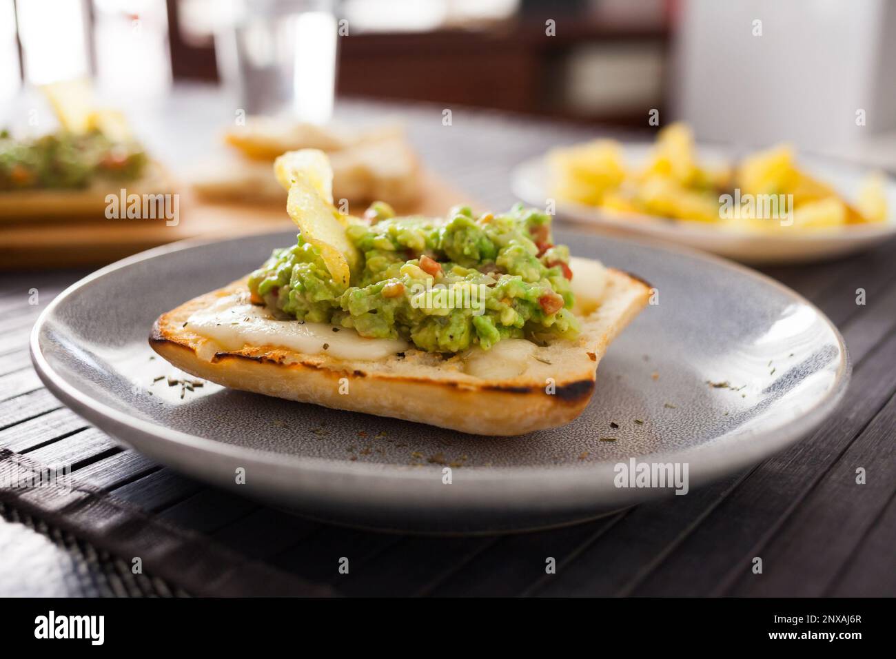 toasted slices of square bread with warm cheese and homemade guacamole ...