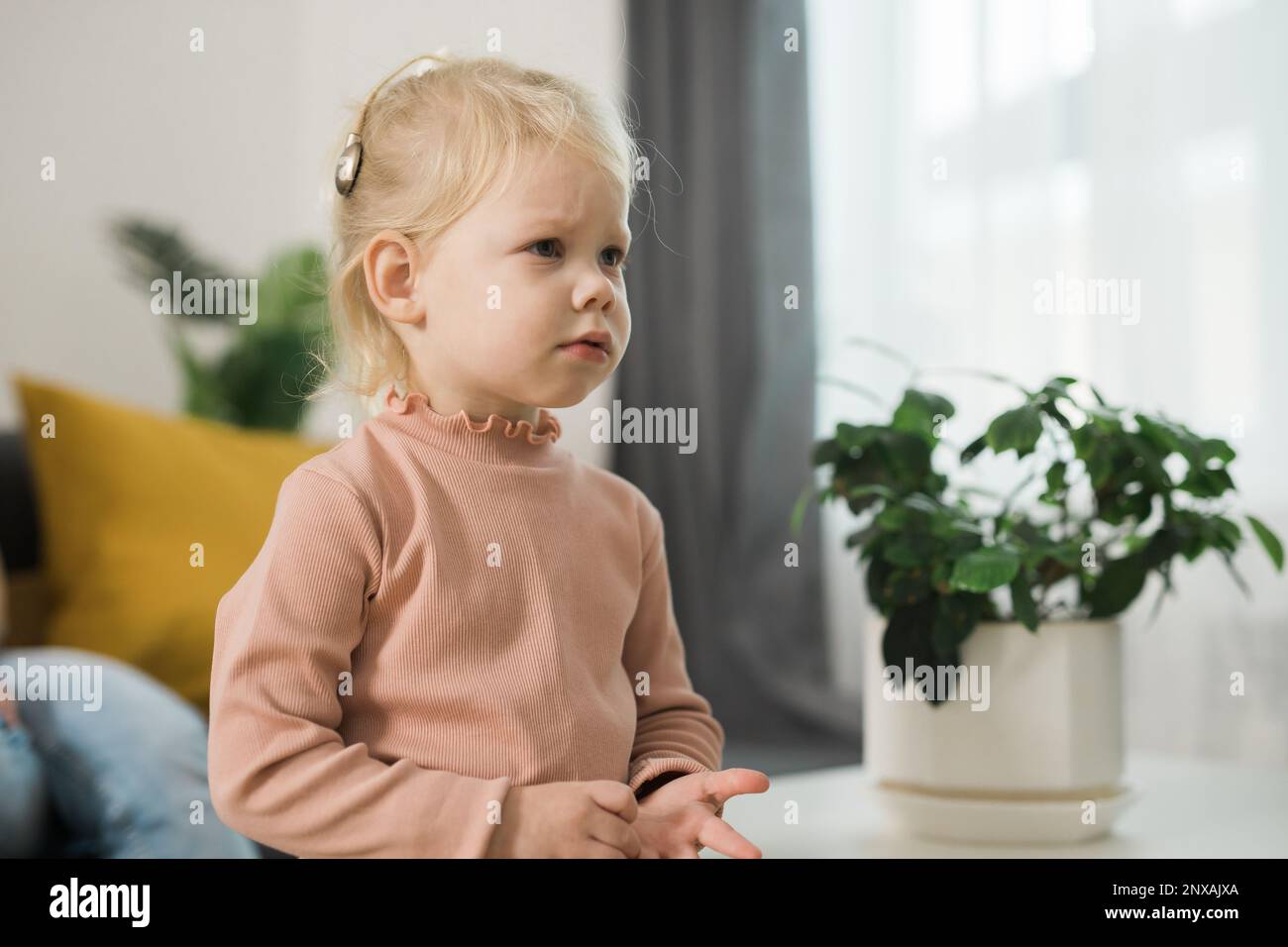 Deaf child girl with cochlear implant studying to hear sounds copy ...