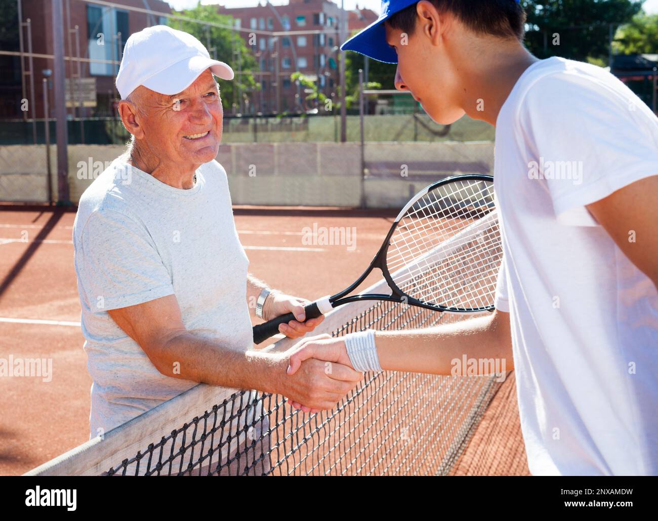tennis players of different generations shake hands before tennis match ...