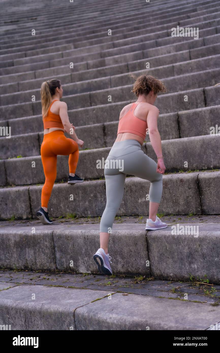 Young caucasian women athletes in sports attire are performing an ...
