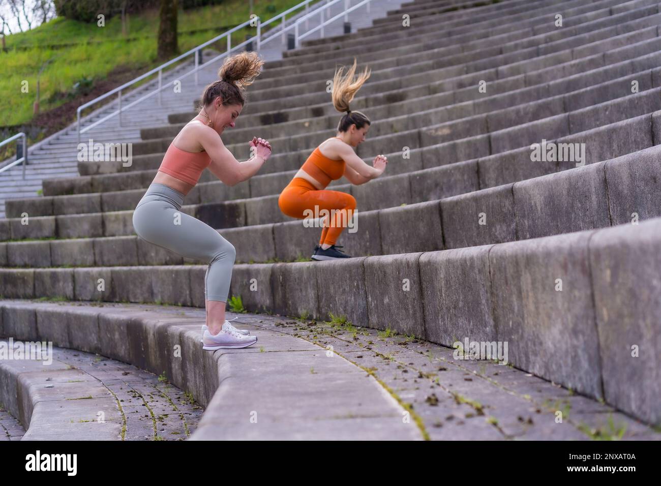 Two young caucasian women doing step jump exercise Stock Photo - Alamy