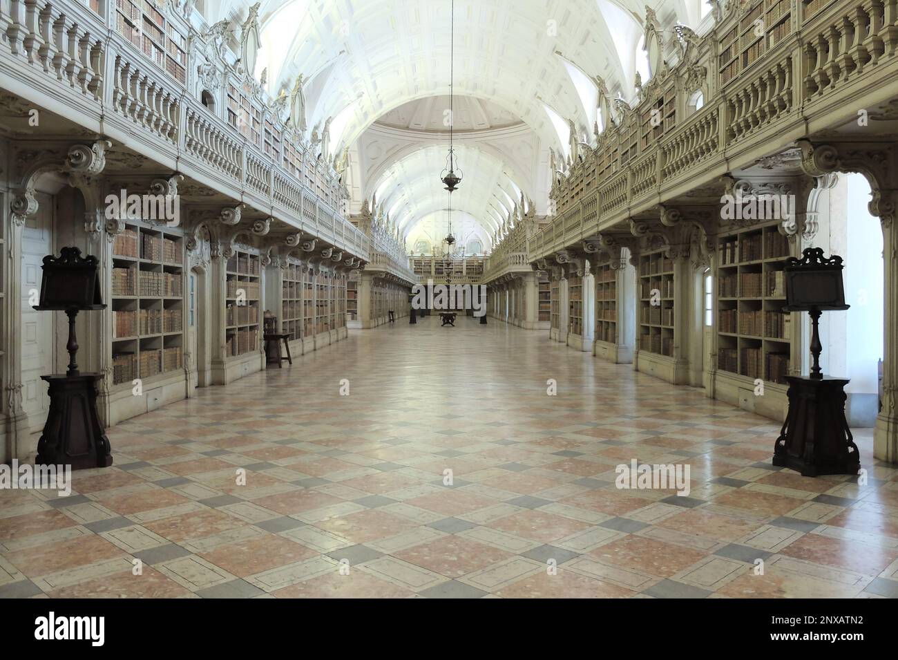 An interior view of an expansive library hallway with numerous ...