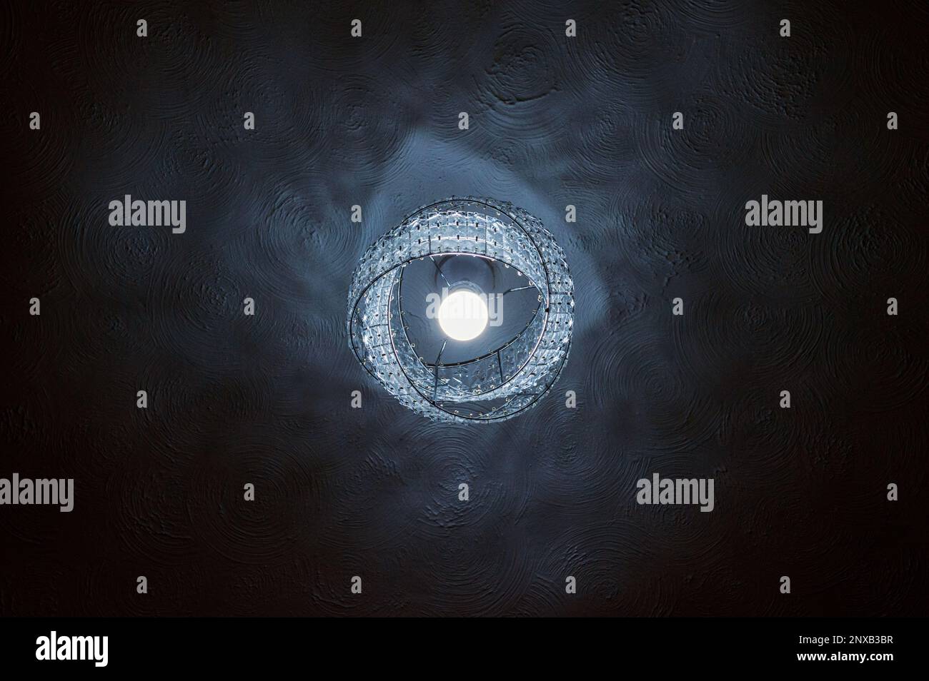 Ceiling lamp on Swirly patterned ceiling at night Stock Photo - Alamy