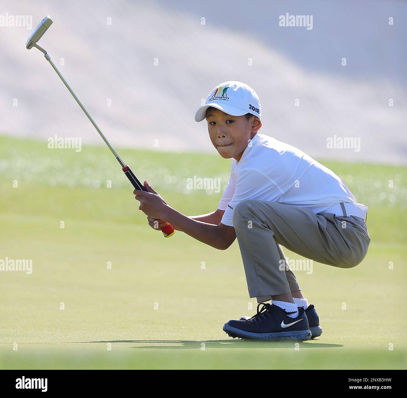 Taighan Chea, of Bothell, Wash., reacts to sinking his putt on the 18th ...