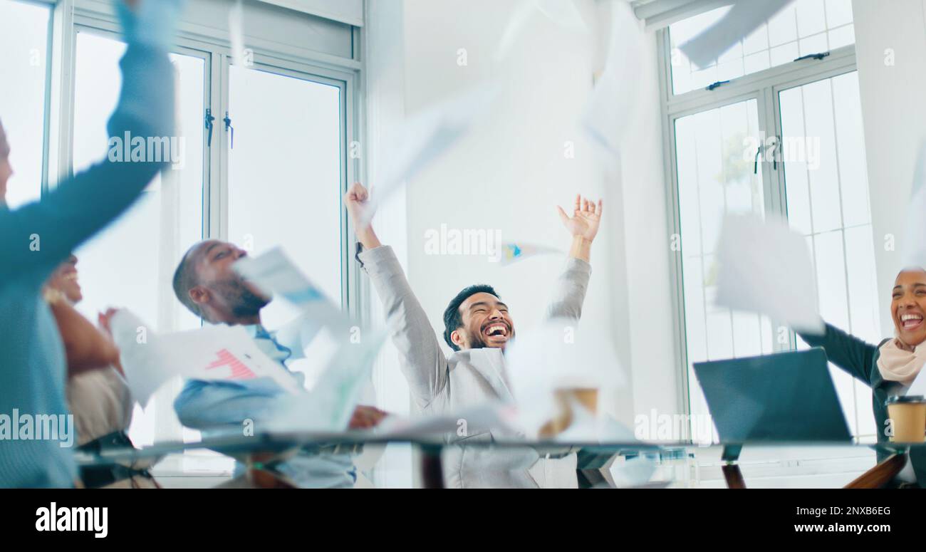 Celebration, teamwork and business meeting with documents in the air ...