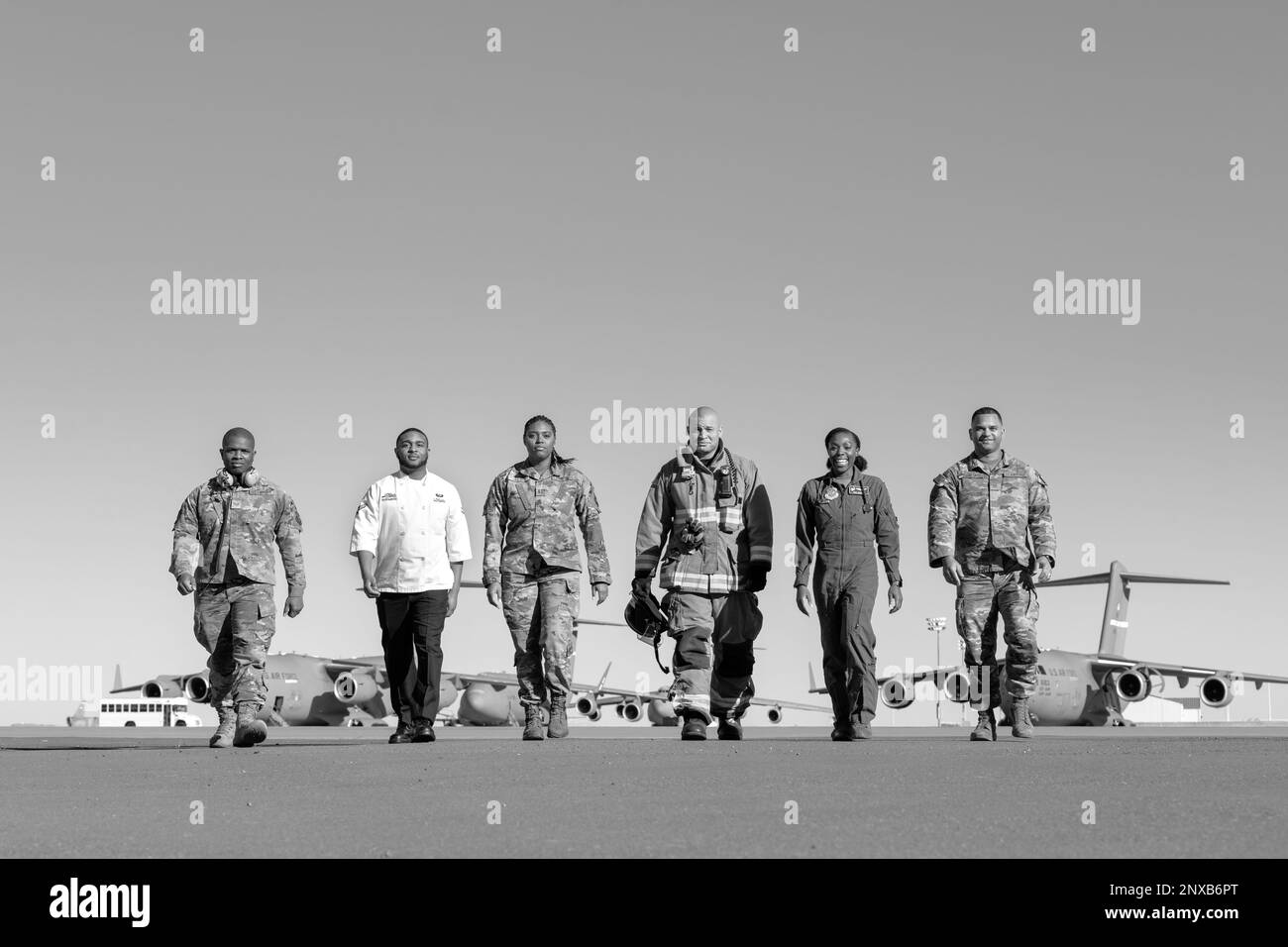 U.S. Airmen walk on the flight line as part of a Black History Month ...