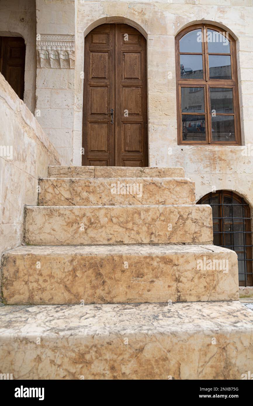 Stone stairs and wooden room door of a traditional Kilis House in Kilis ...