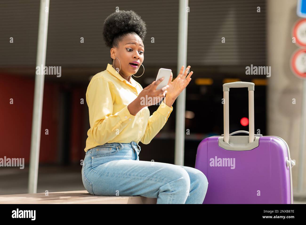 Shocked Black Female Tourist Using Cellphone Having Problem Sitting ...