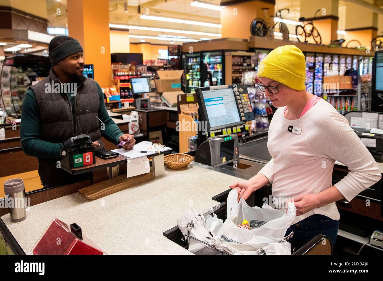 In this Friday, March 16, 2018 photo, Omar Robinson, left, waits for ...
