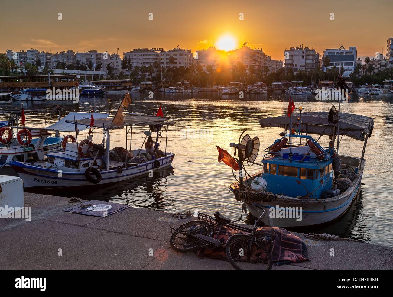 Fishing boats in the sunset harbor in Mersin (İçel) city of Turkey ...