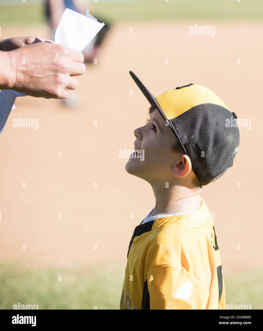 Smiling baseball player listening to his coach, California, USA Stock ...
