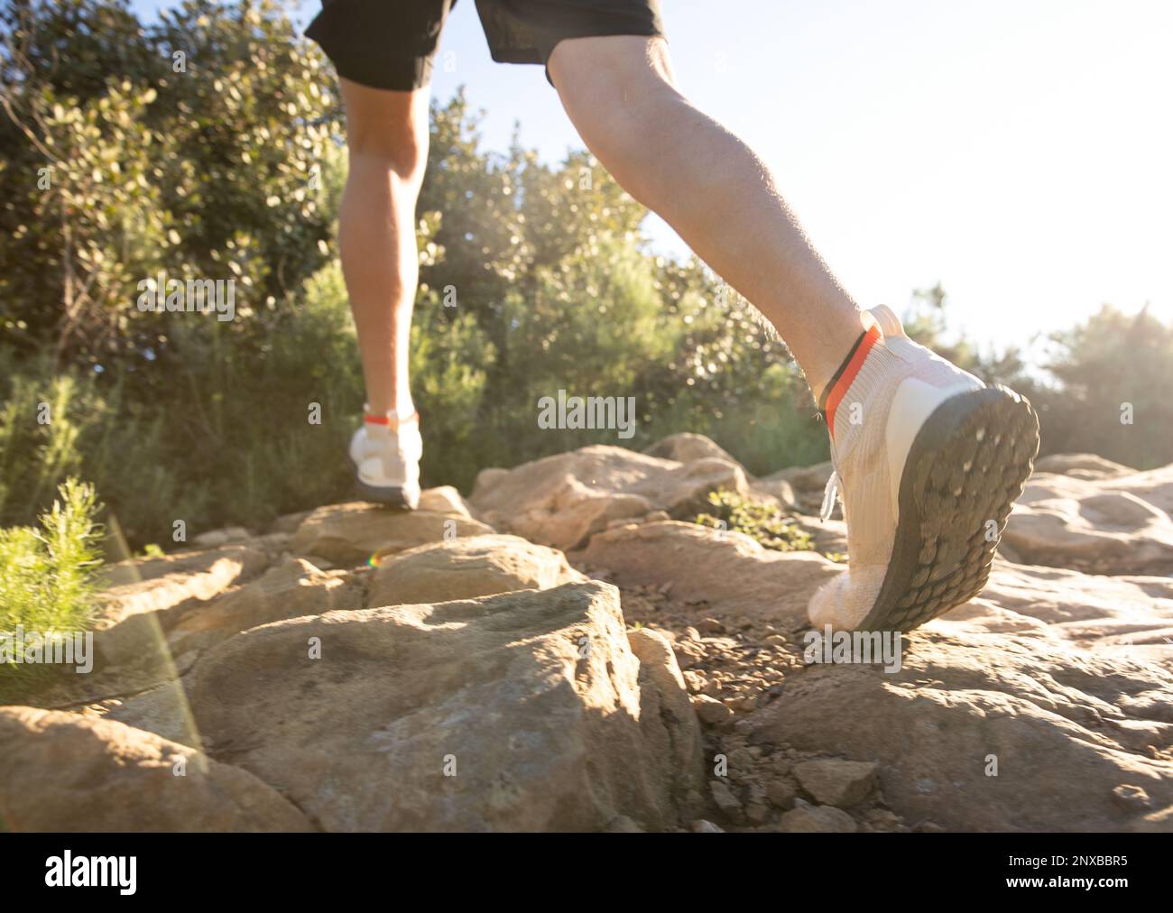 Teenage boy running across rocks, California, USA Stock Photo - Alamy