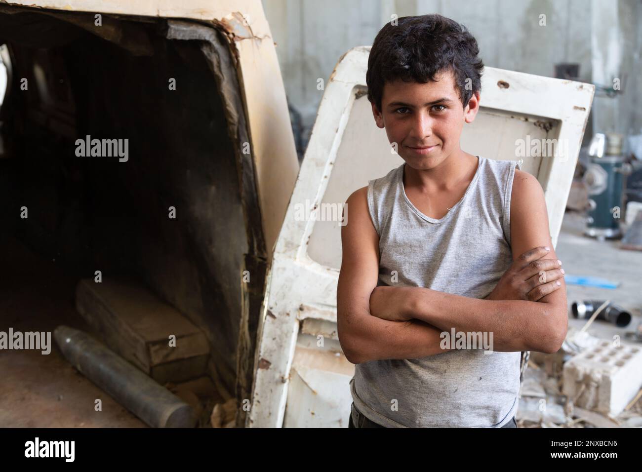 Syrian child worker at auto mechanic in selective focus. Child worker ...